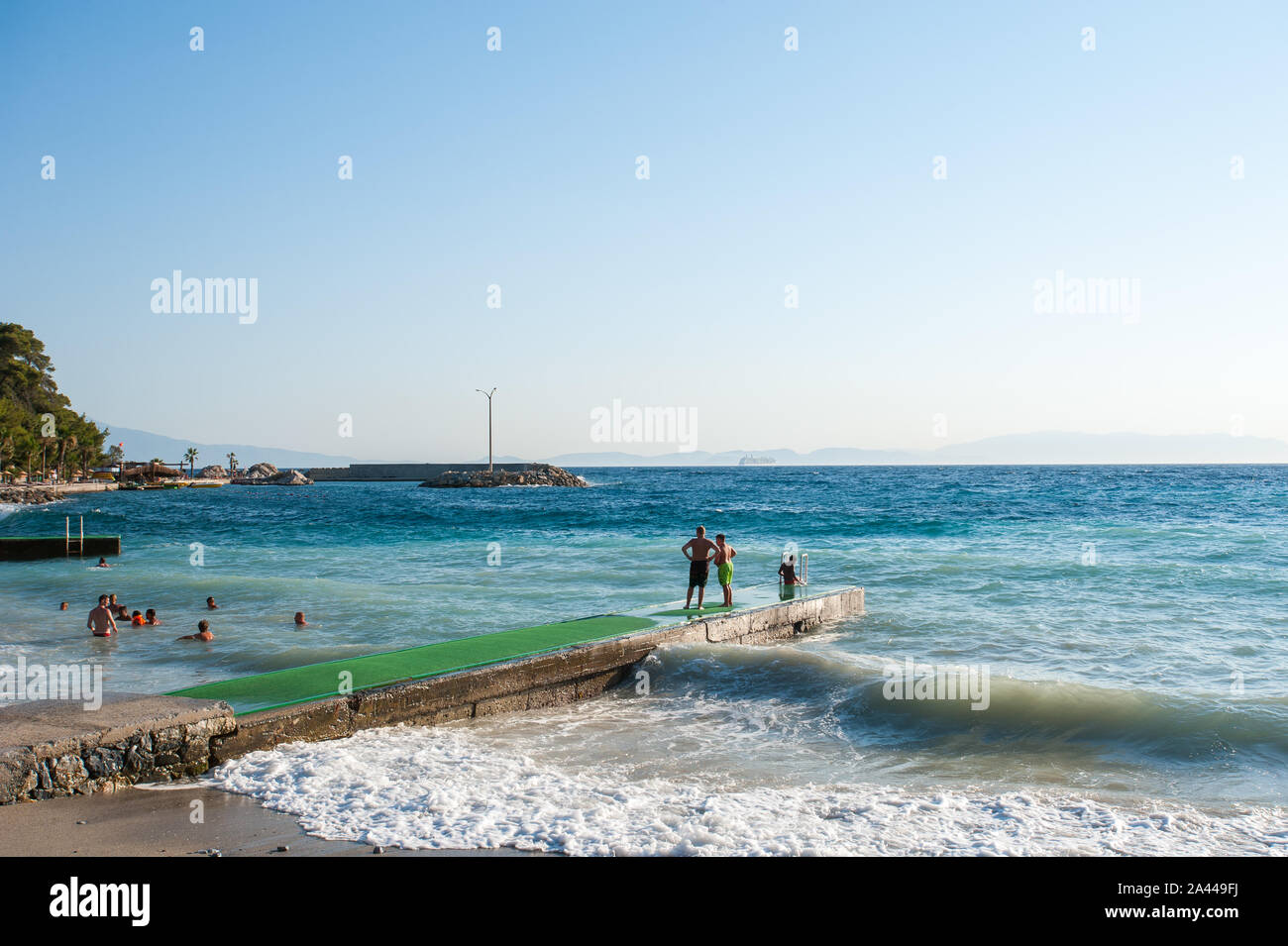 An ocean shorebreak in front view. Big beautiful green blue wave ...