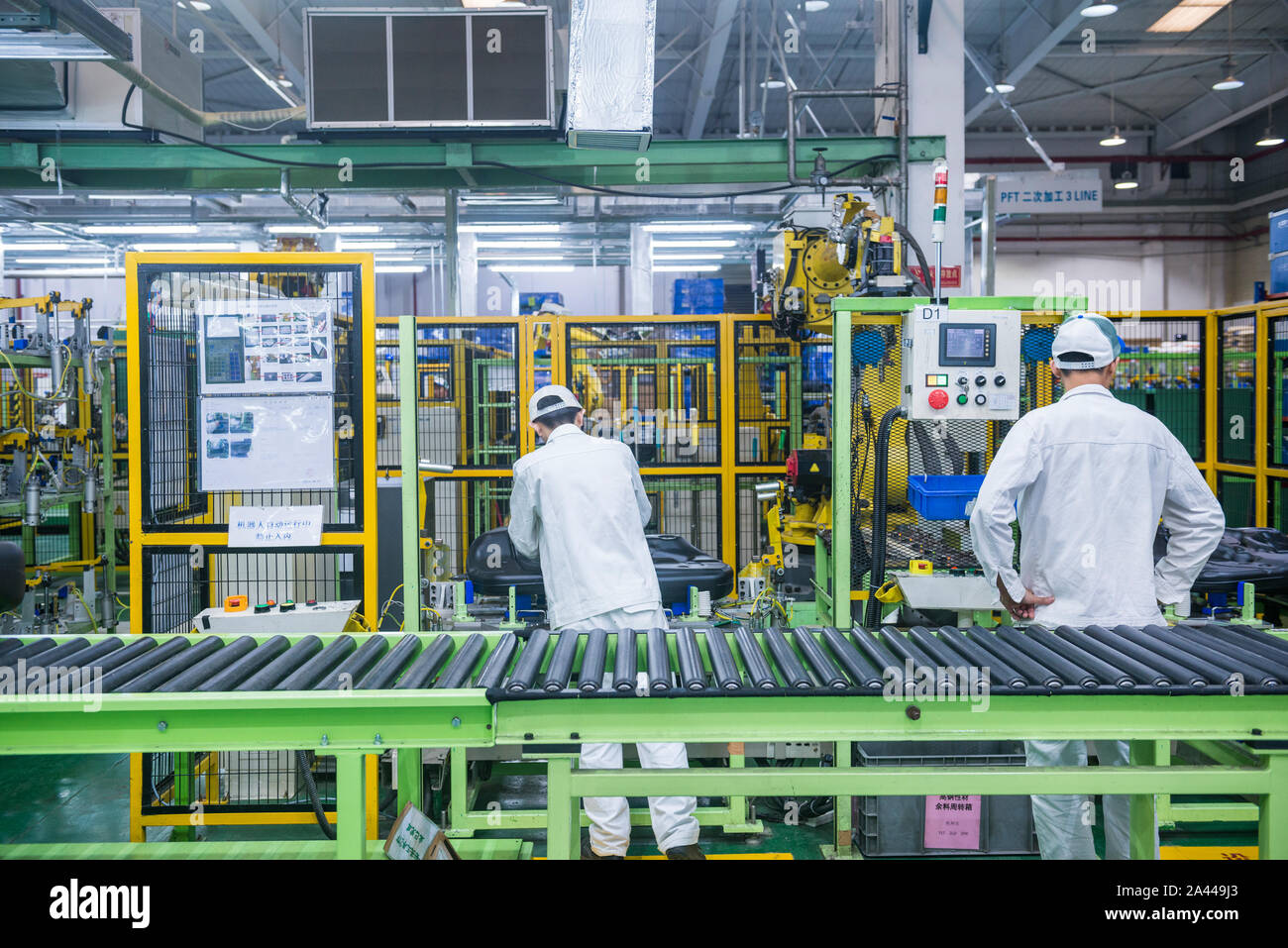 --FILE--Chinese workers labor on the assembly line at an auto plant in ...