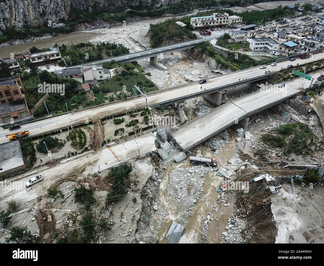 Aerial view of collapsed viaduct and overturned truck due to mudslide ...