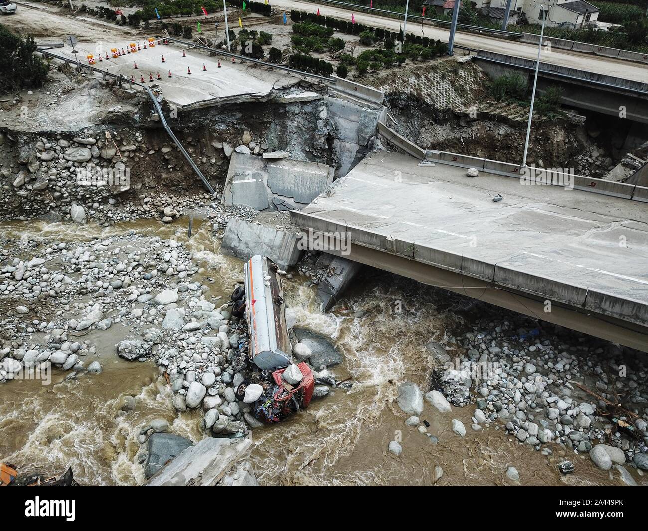 Aerial view of collapsed viaduct and overturned truck due to mudslide ...