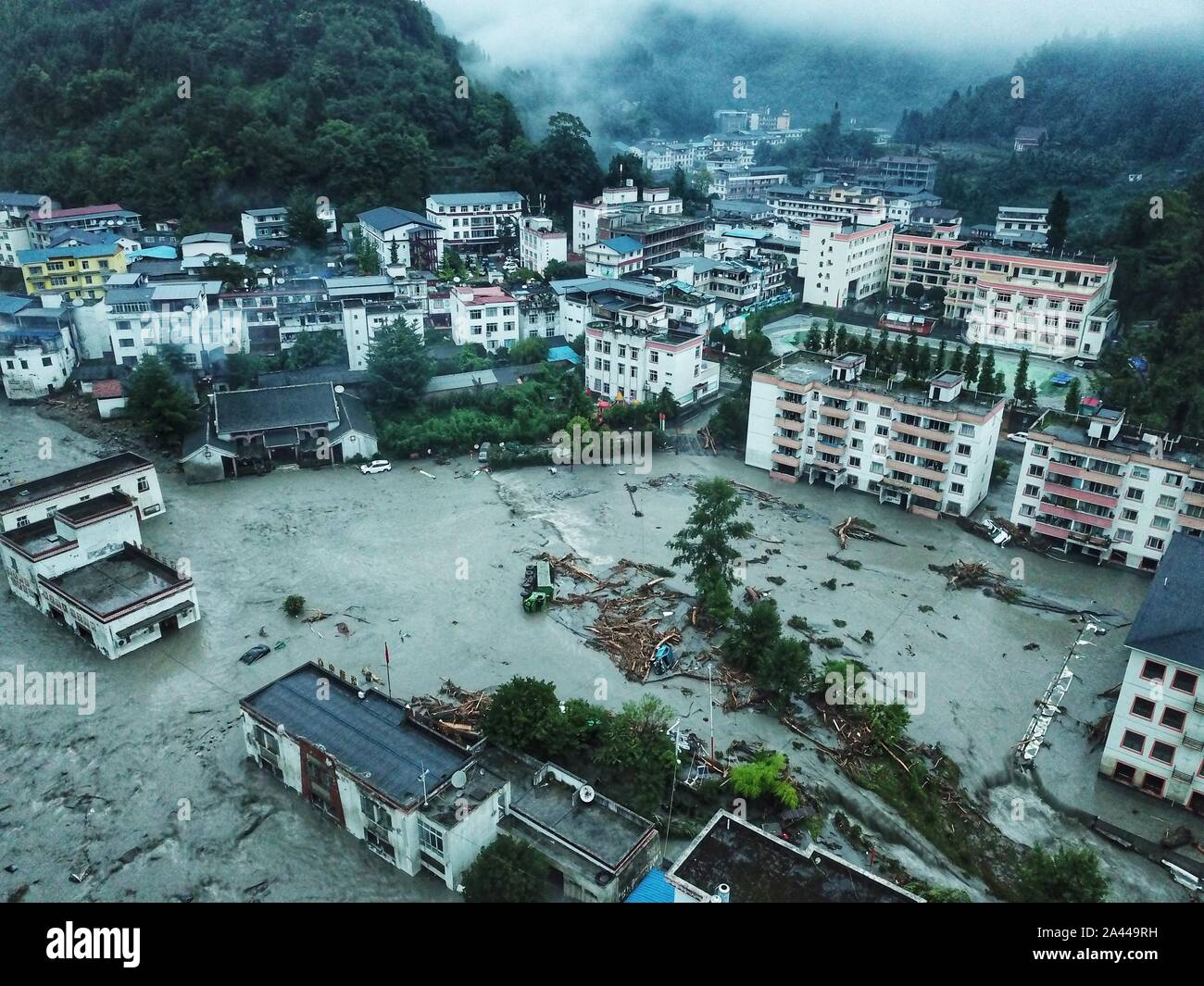 Roads and residential buildings are devastated by multiple mudslides ...