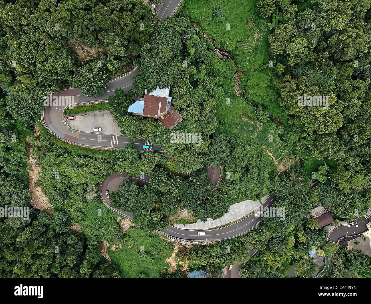 Aerial view of a winding mountain road with 5 curves around mountains ...