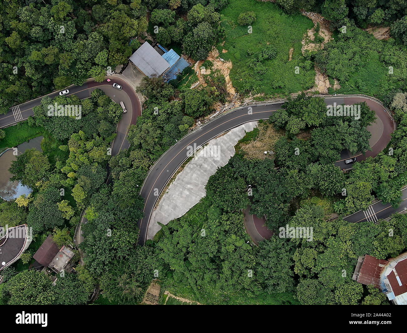 Aerial view of a winding mountain road with 5 curves around mountains ...