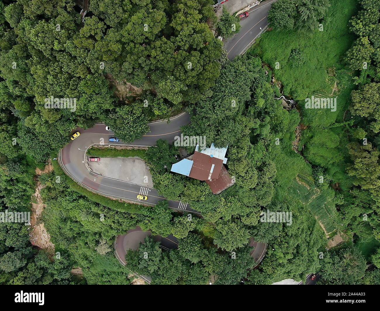 Aerial view of a winding mountain road with 5 curves around mountains ...