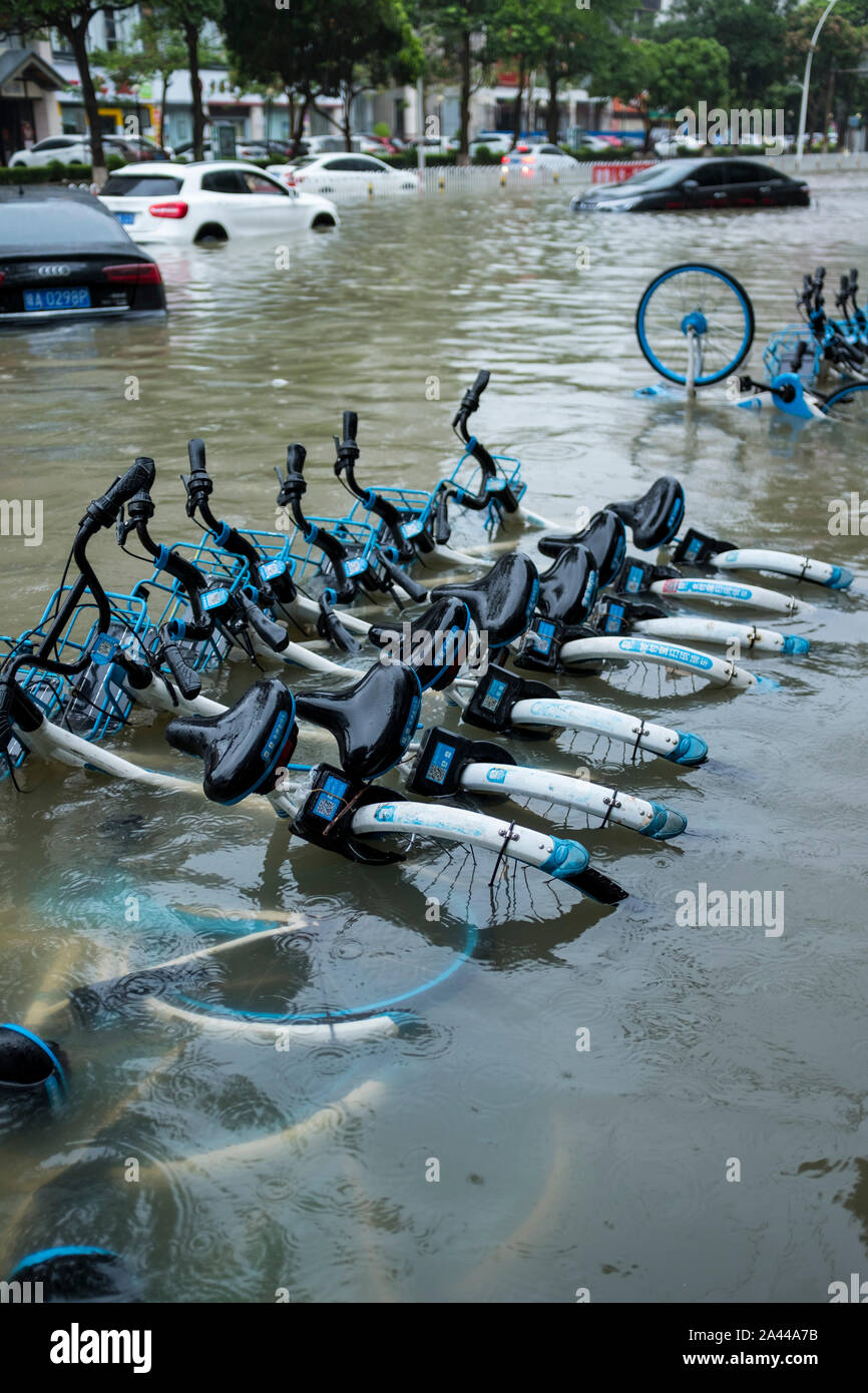 Bicycles of Chinese bike-sharing services and motorcycles are submerged ...
