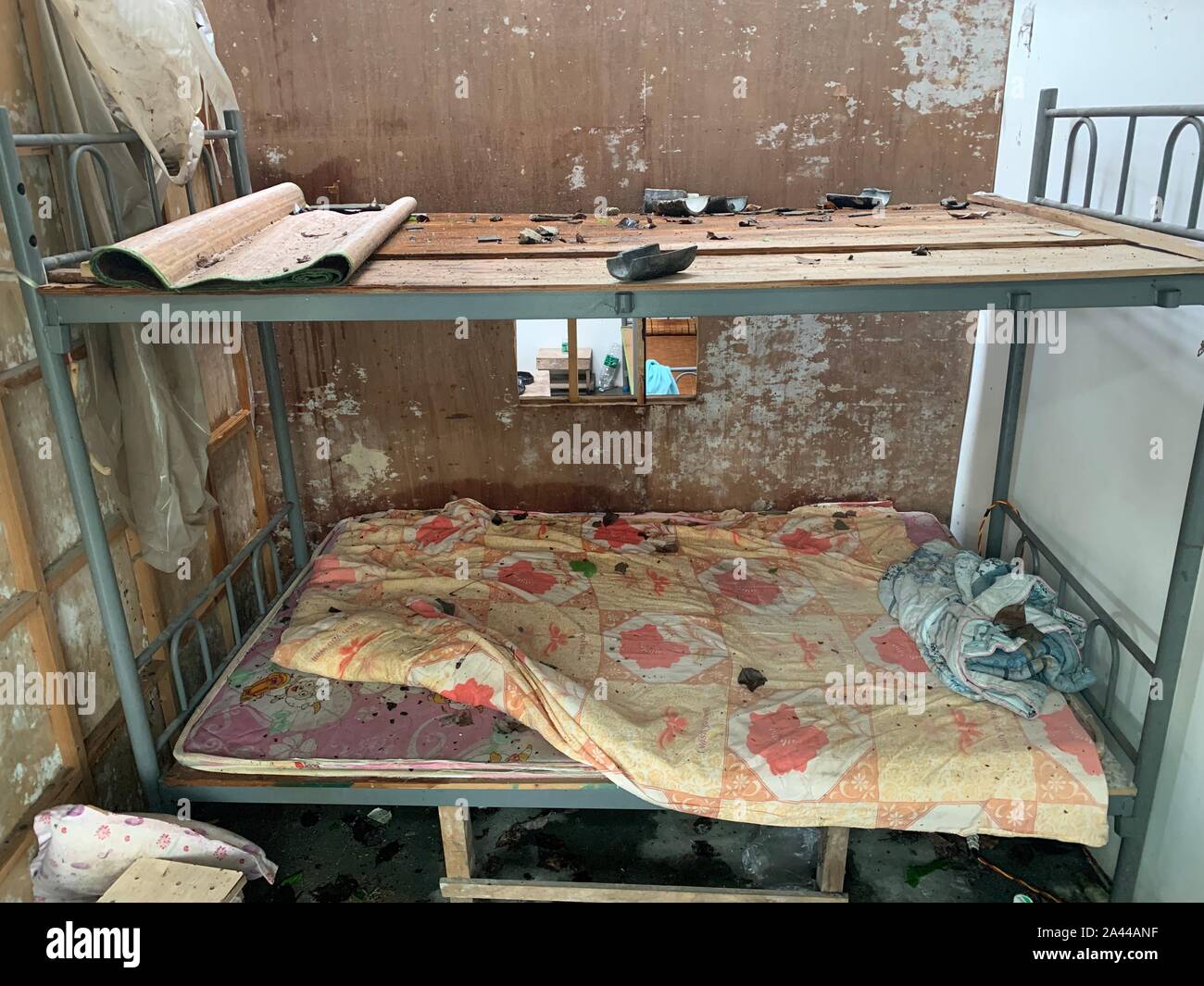Fallen bricks and dirt are everywhere on a bunk bed after tornado hits ...