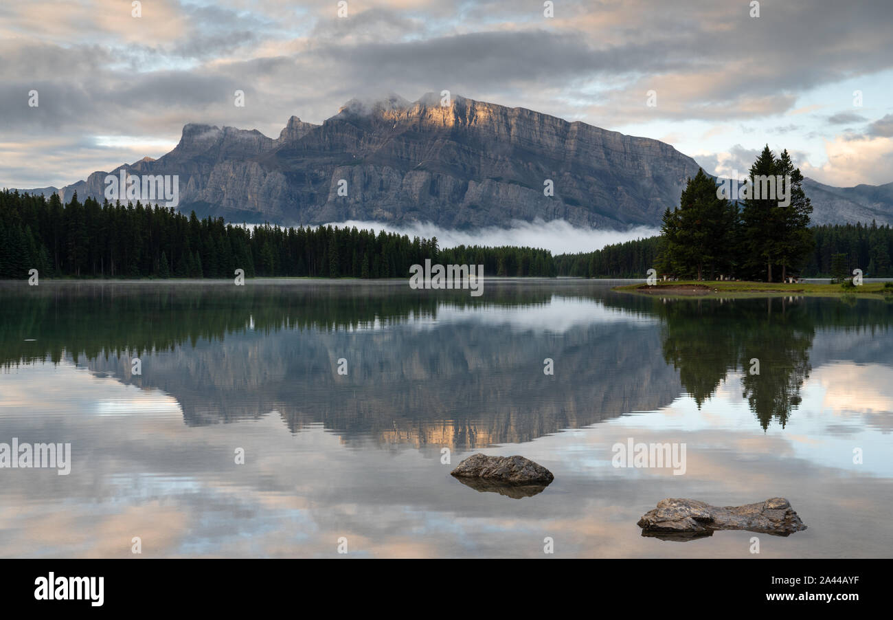 Panoramic image of Mount Rundle reflecting in Two Jack Lake with early ...