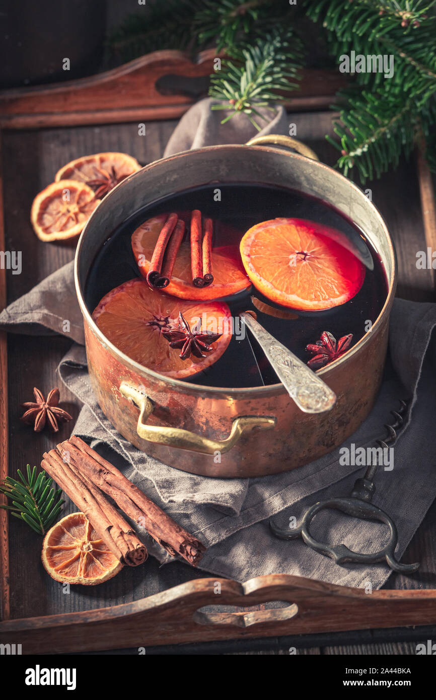 Aromatic and homemade mulled red wine on rustic table Stock Photo - Alamy