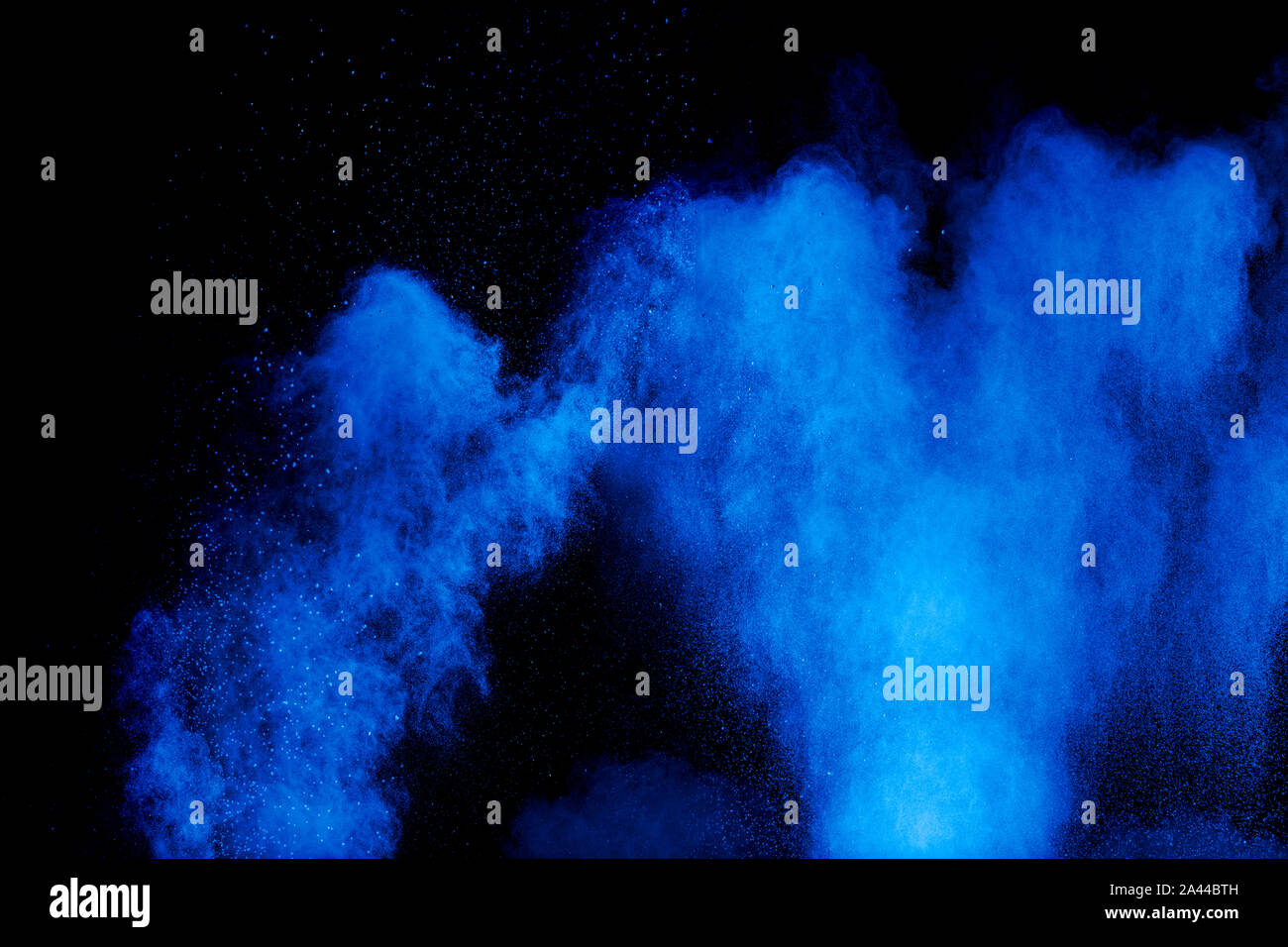 Blue color dust particles splash cloud on black background.Color powder ...