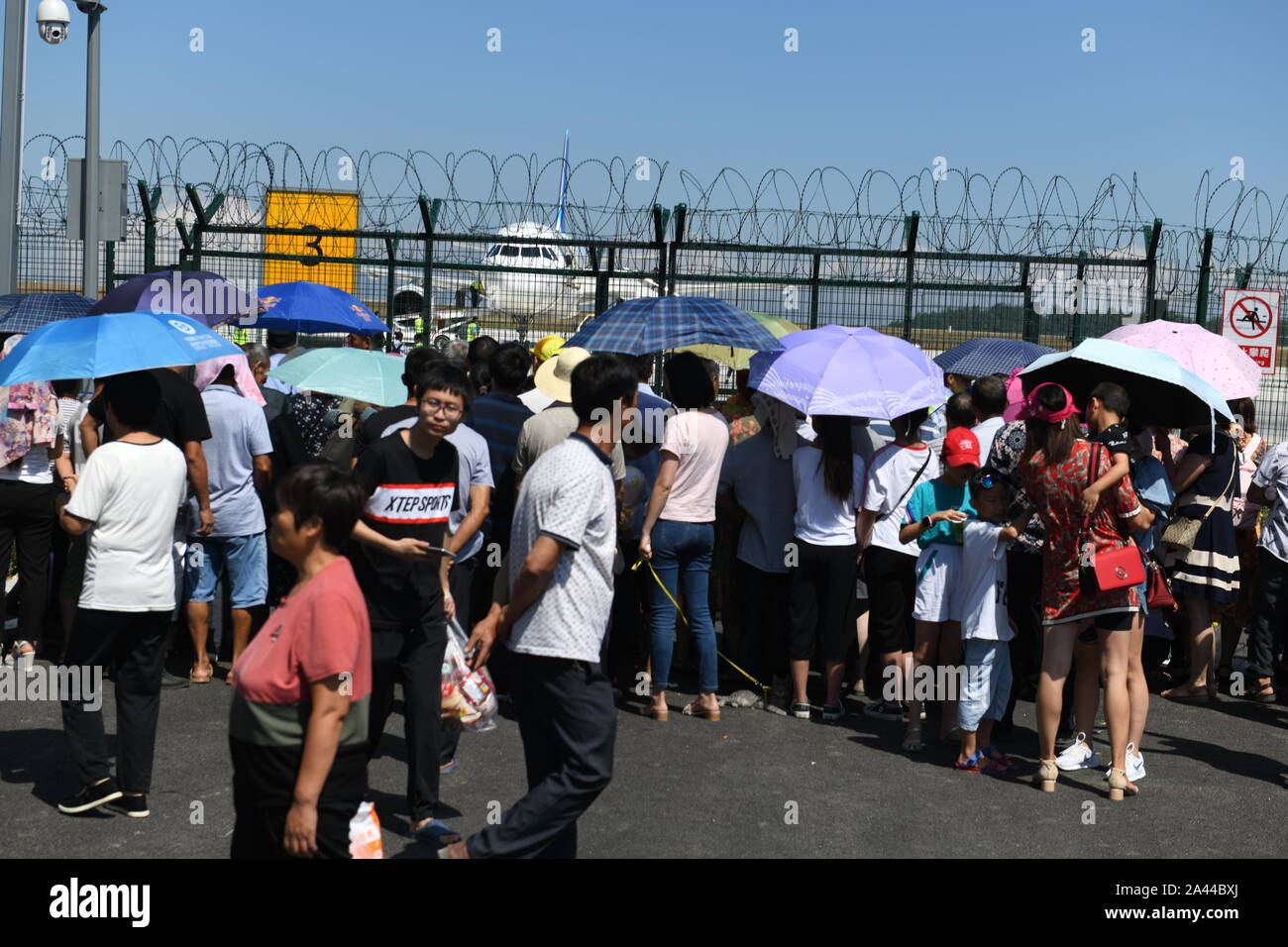 Local residents crowd the Chongqing Wushan Airport, dubbed a "high-in ...