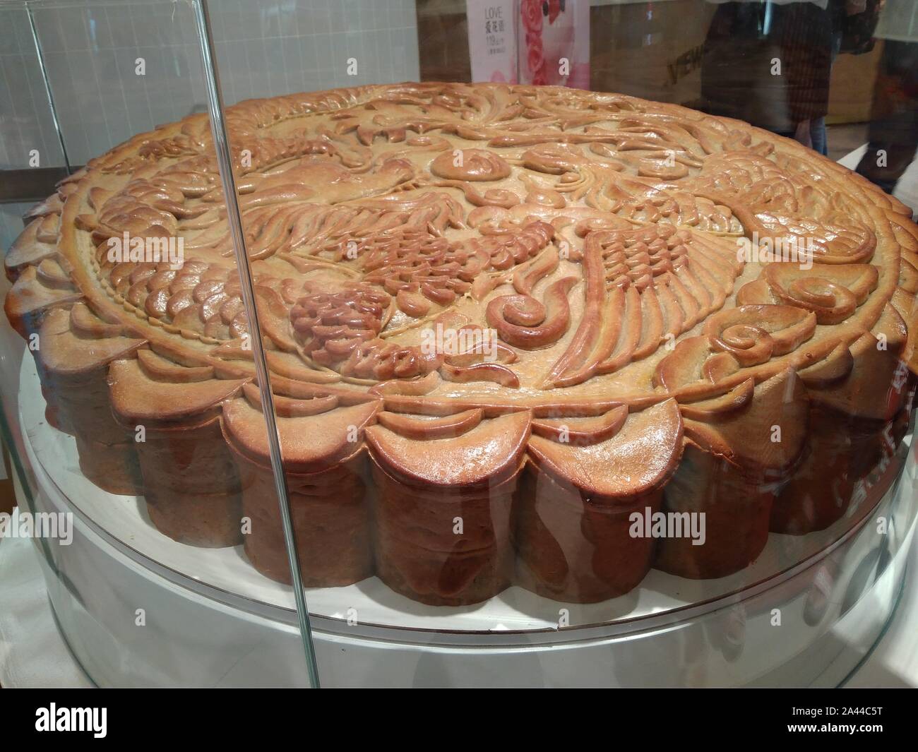 Customers view a huge mooncake weighed 400 kilograms in front of a ...