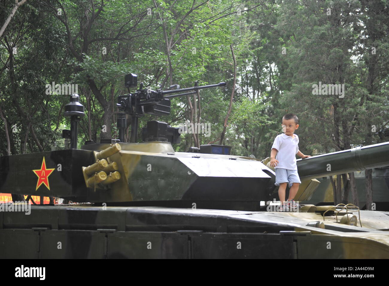 Citizens pose to photo with warcraft, tank, machine gun and other army ...