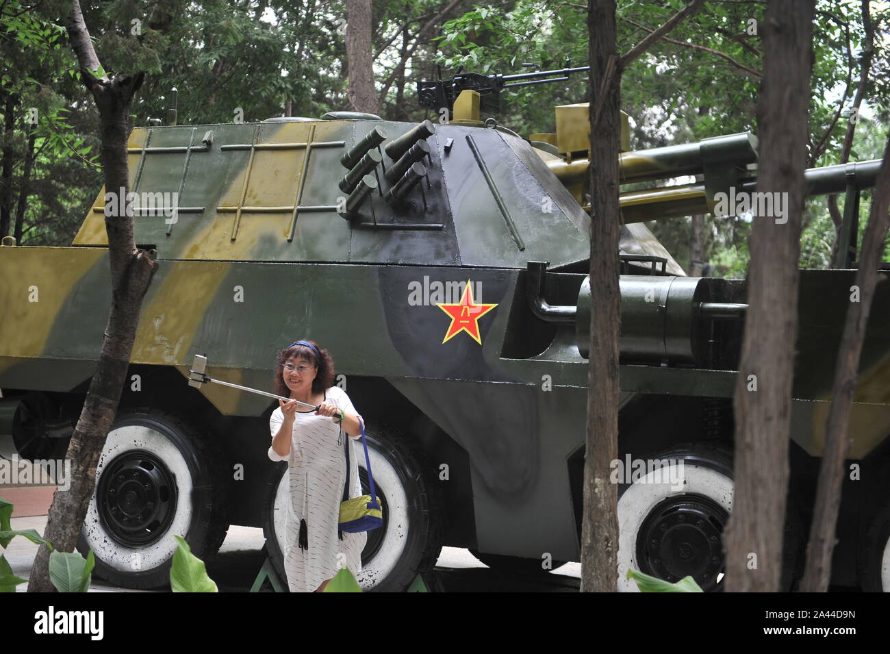 Citizens pose to photo with warcraft, tank, machine gun and other army ...