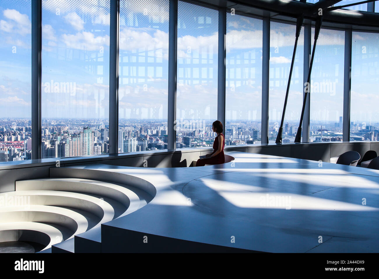 A Chinese woman reads a book in the 52nd-storey Duoyun Bookstore, which ...