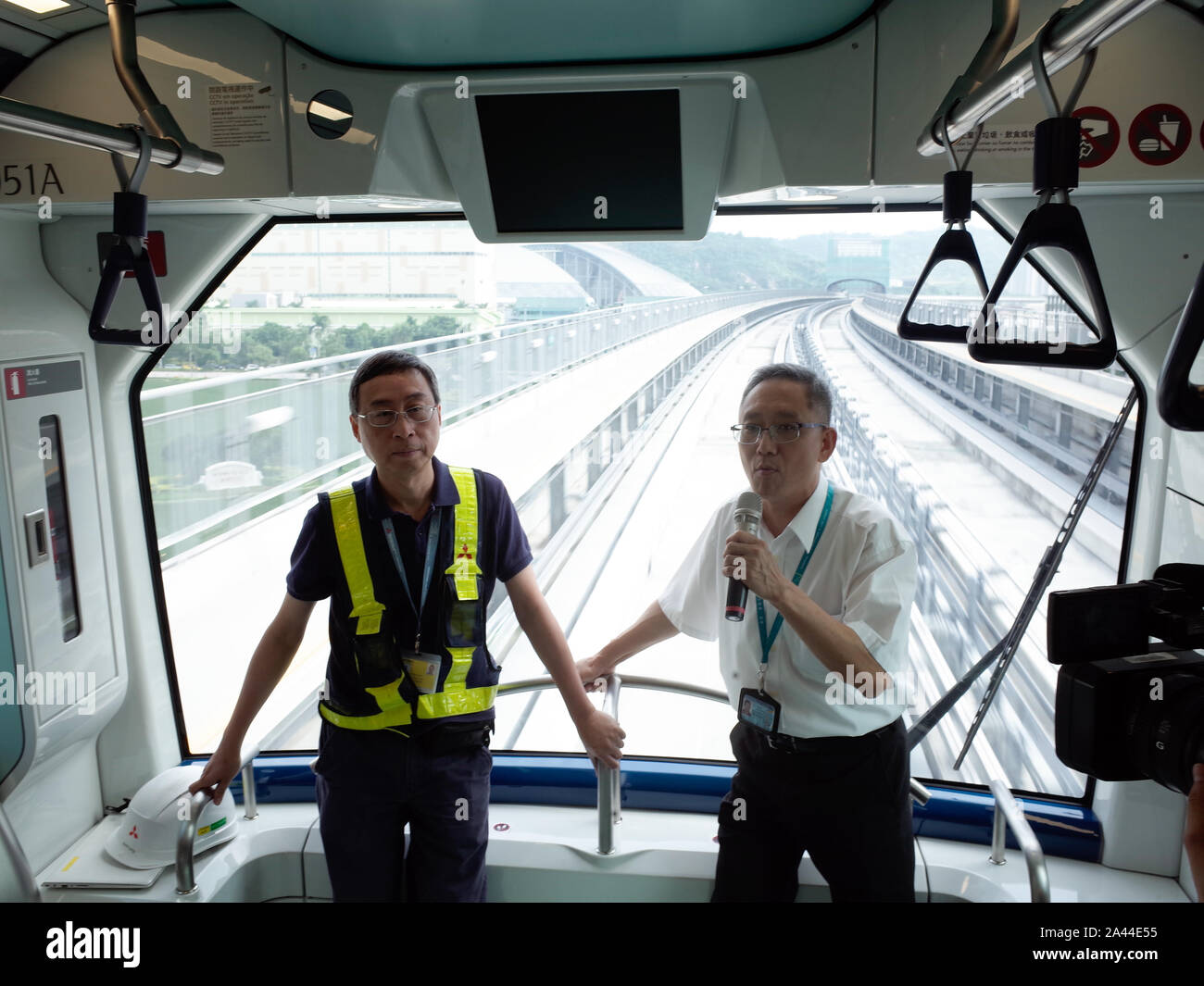 Chinese workers introduce the Light Rail Transit (LRT) system at the ...