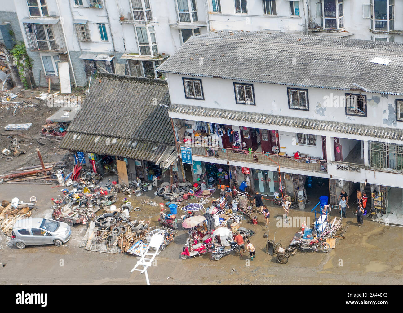 Residential buildings are roads are covered with stones and mud after ...