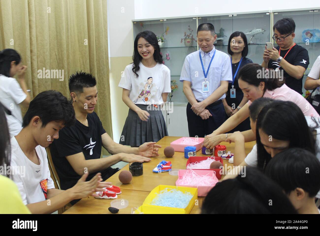 Jeremy Shu-How Lin, or simply Jeremy Lin, left black, is interacting ...