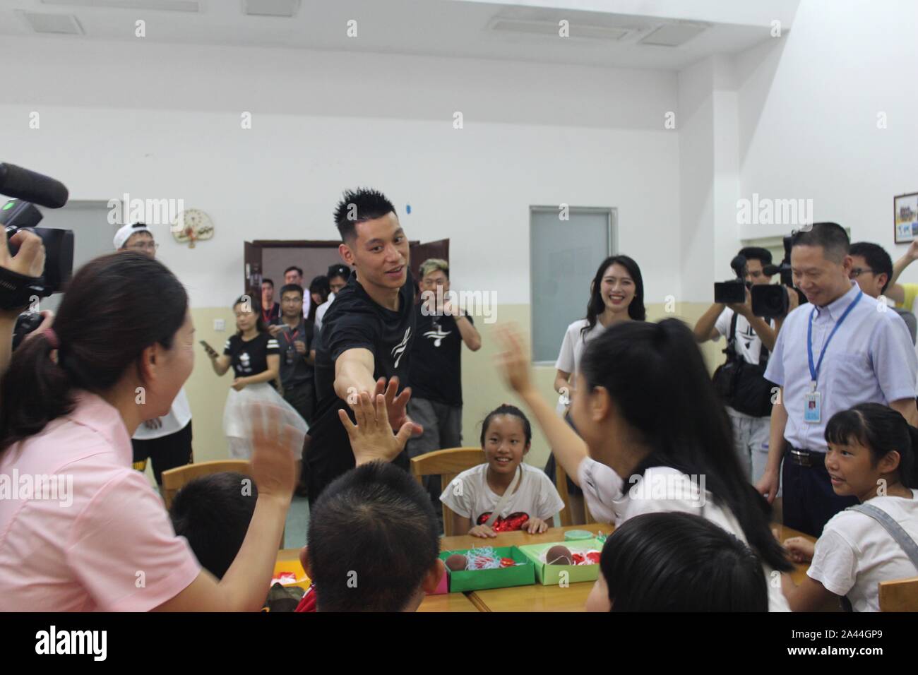 Jeremy Shu-How Lin, or simply Jeremy Lin, tallest, is interacting with ...