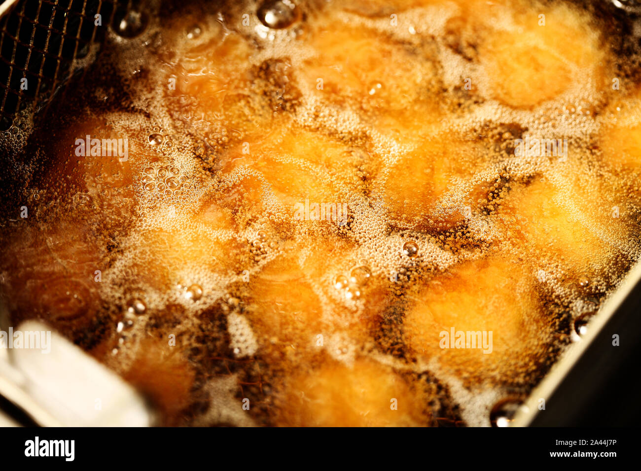 fried food in oil in a restaurant Stock Photo - Alamy