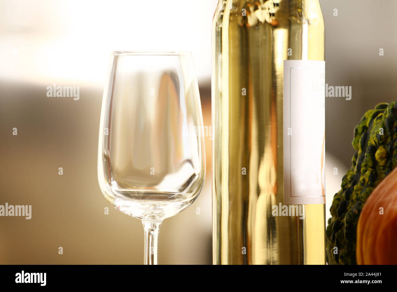White wine glass with white wine buttle Stock Photo - Alamy