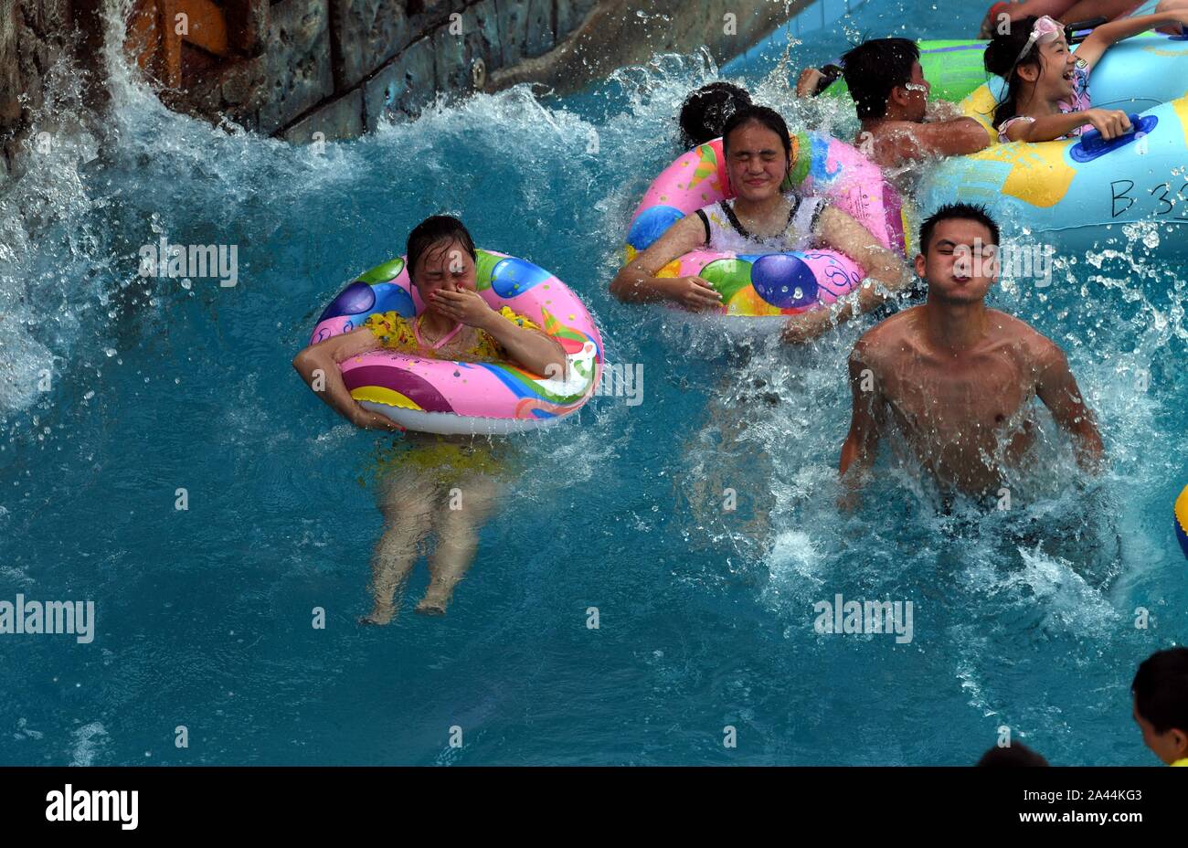 Chinese holidaymakers crowd a swimming pool at a water park to escape ...