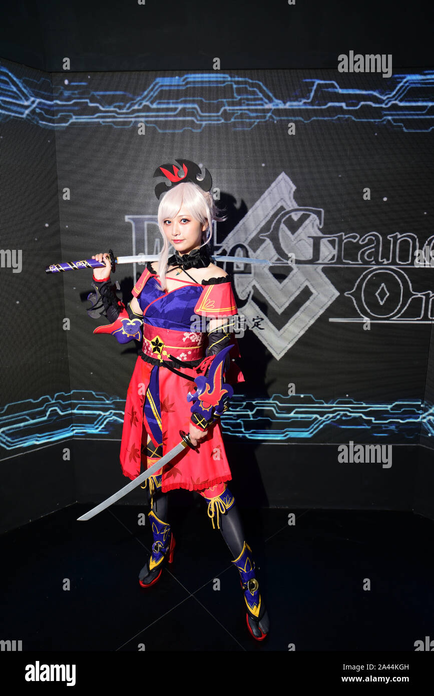 A Chinese showgirl dressed in cosplay costume featuring Miyamoto ...
