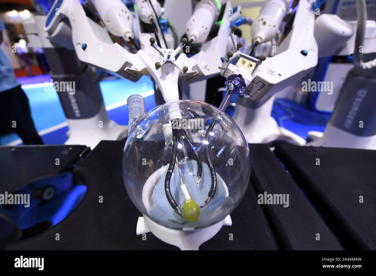 A surgical robot of laparoscopy puts sutures on a grape during the 2019 ...