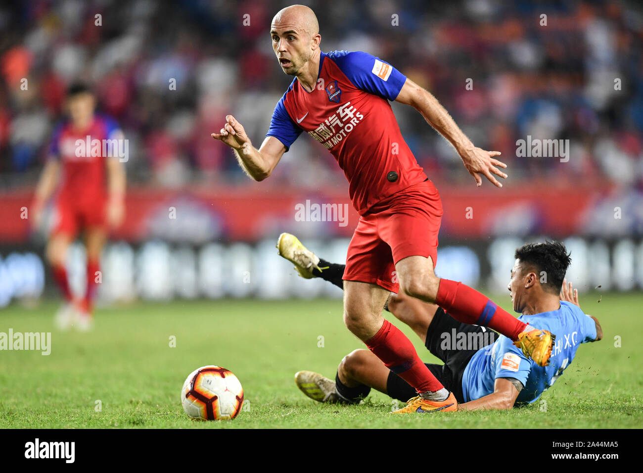 Polish football player Adrian Mierzejewski, left, of Chongqing SWM ...