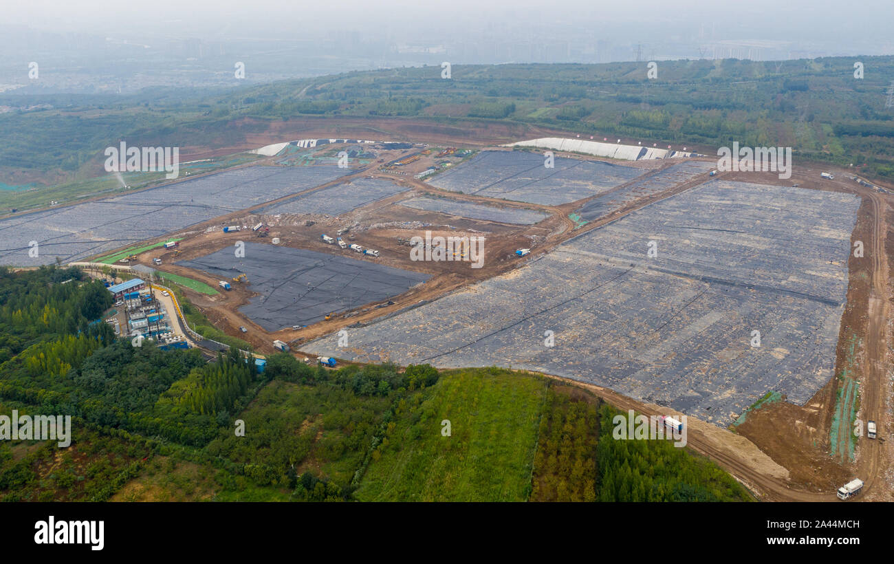 Chinese workers sort out and bury kitchen waste at the Jiangcungou ...