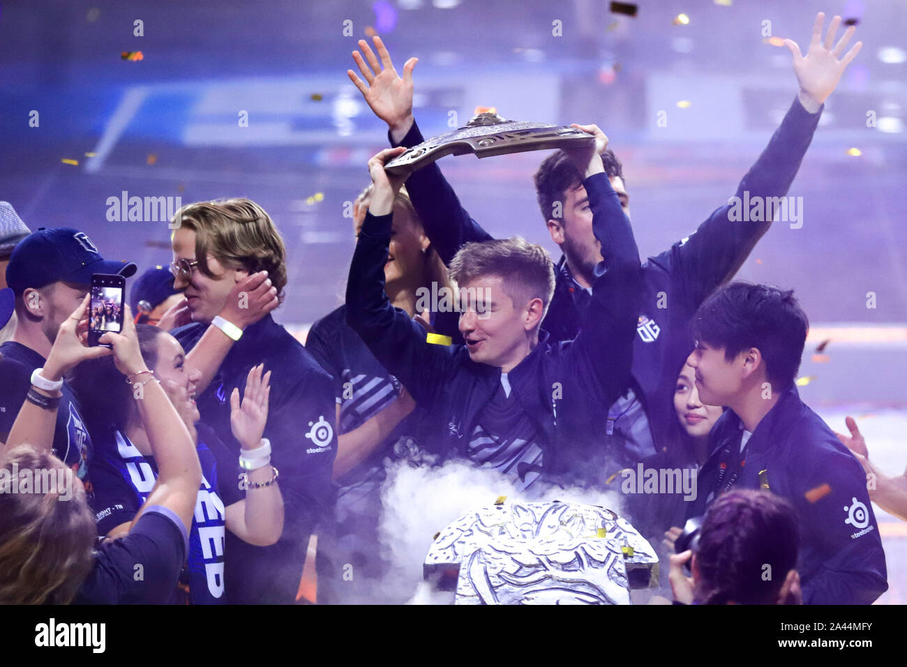 Players of Europe's OG pose for photos with their trophy after winning ...