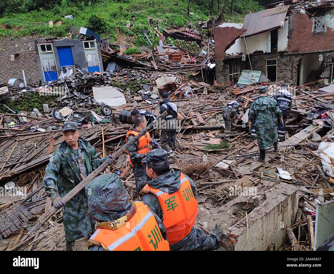 Chinese rescuers search for victims and survivors in debris of a ...