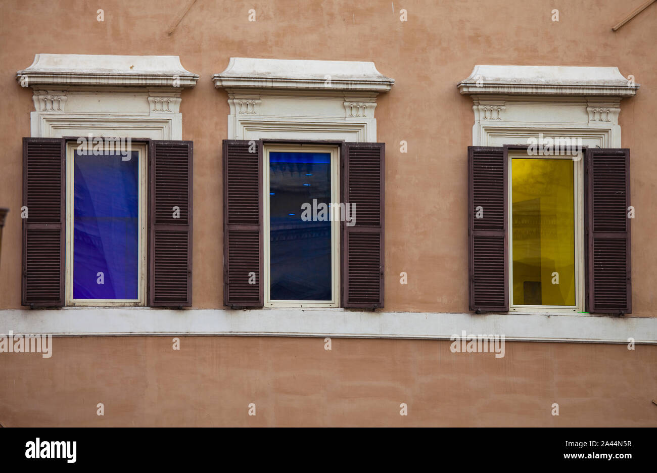 three colored windows overlooking the Trevi Fountain. Rome, Lazio ...