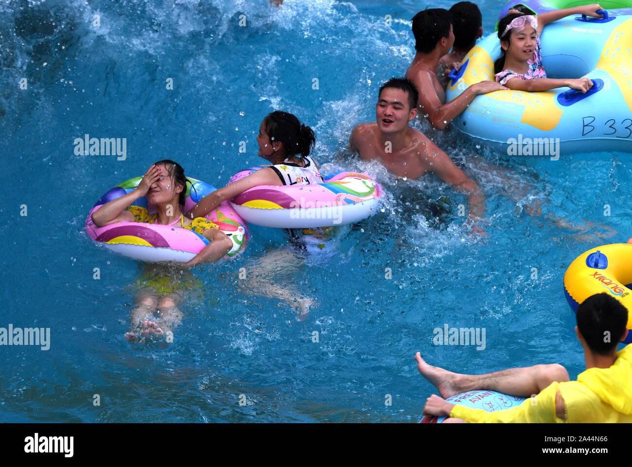 Chinese holidaymakers crowd a swimming pool at a water park to escape ...