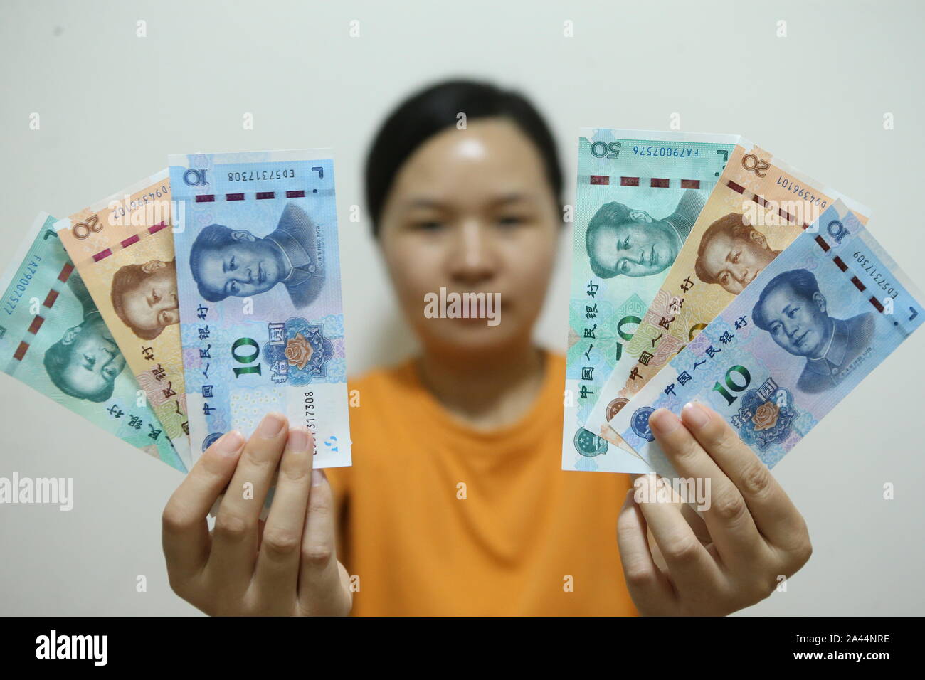 A person shows the fifth set of RMB 2019 edition in Shanghai, China, 30 ...