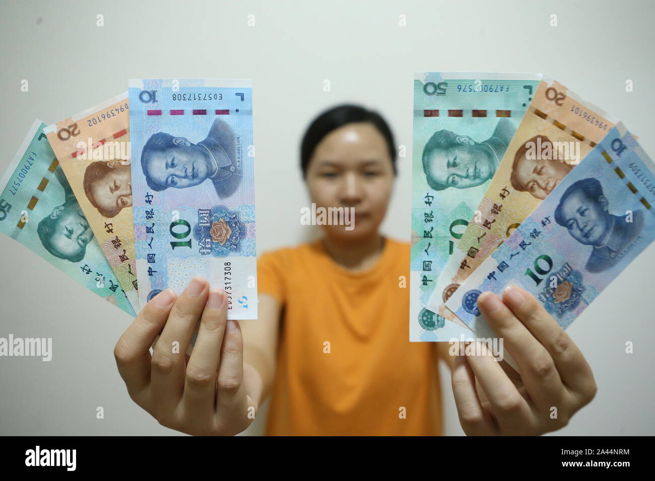 A person shows the fifth set of RMB 2019 edition in Shanghai, China, 30 ...