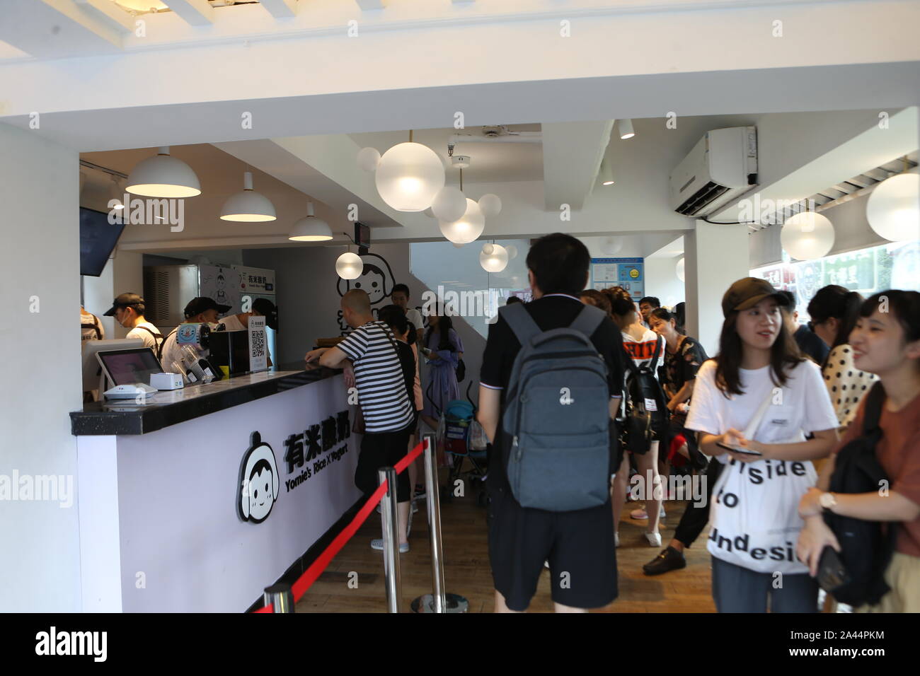 Visitors queue up to buy cups of Yomie's Purple Rice x Yogurt in the ...