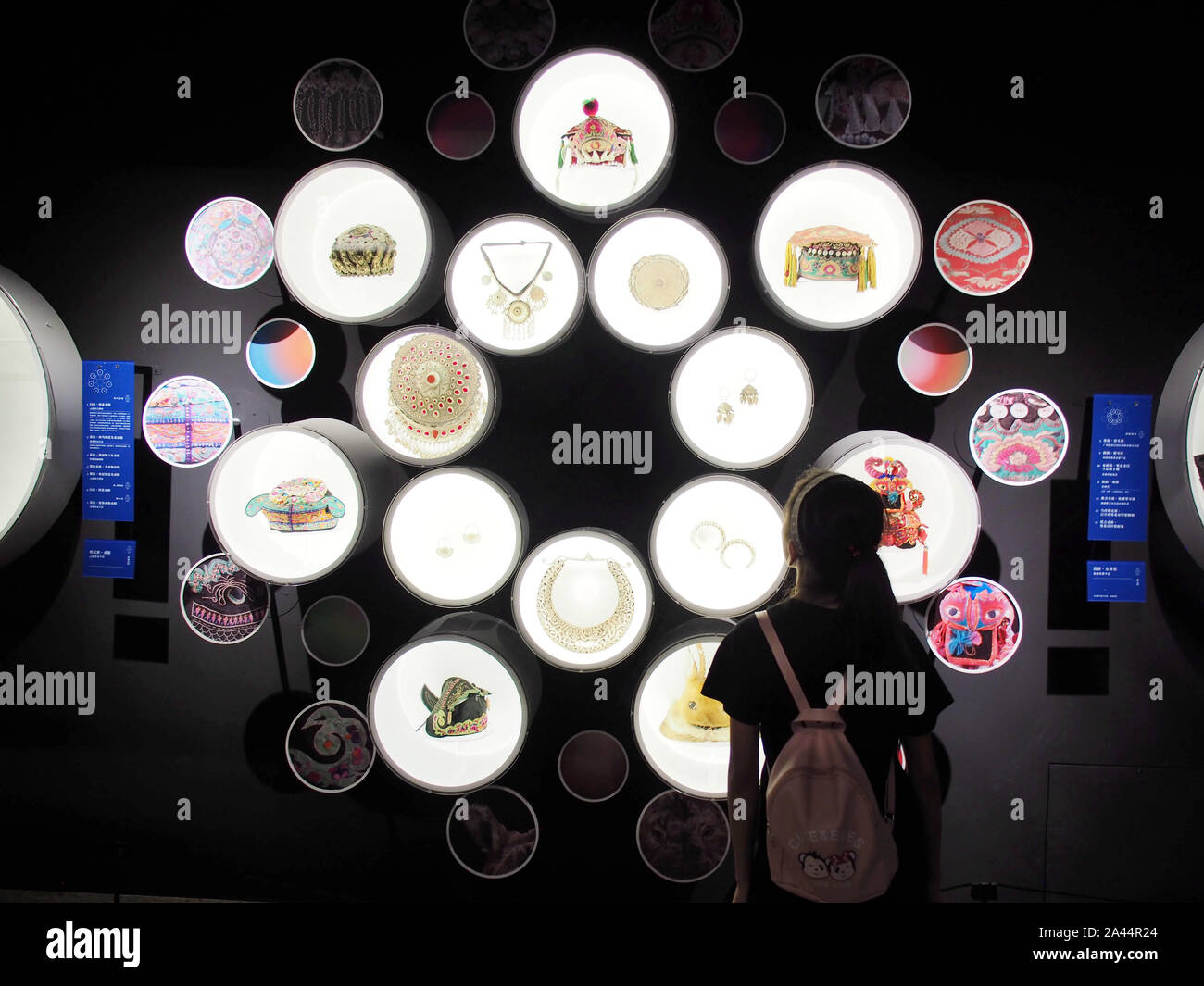 Visitors view an artwork featuring ethnic decorative patterns during an ...