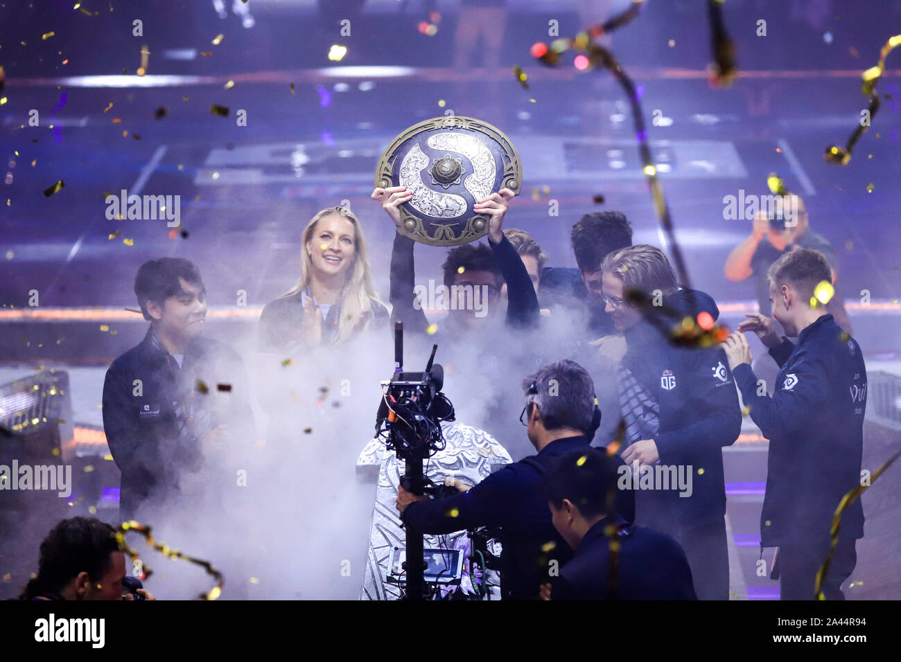 Players of Europe's OG pose for photos with their trophy after winning ...