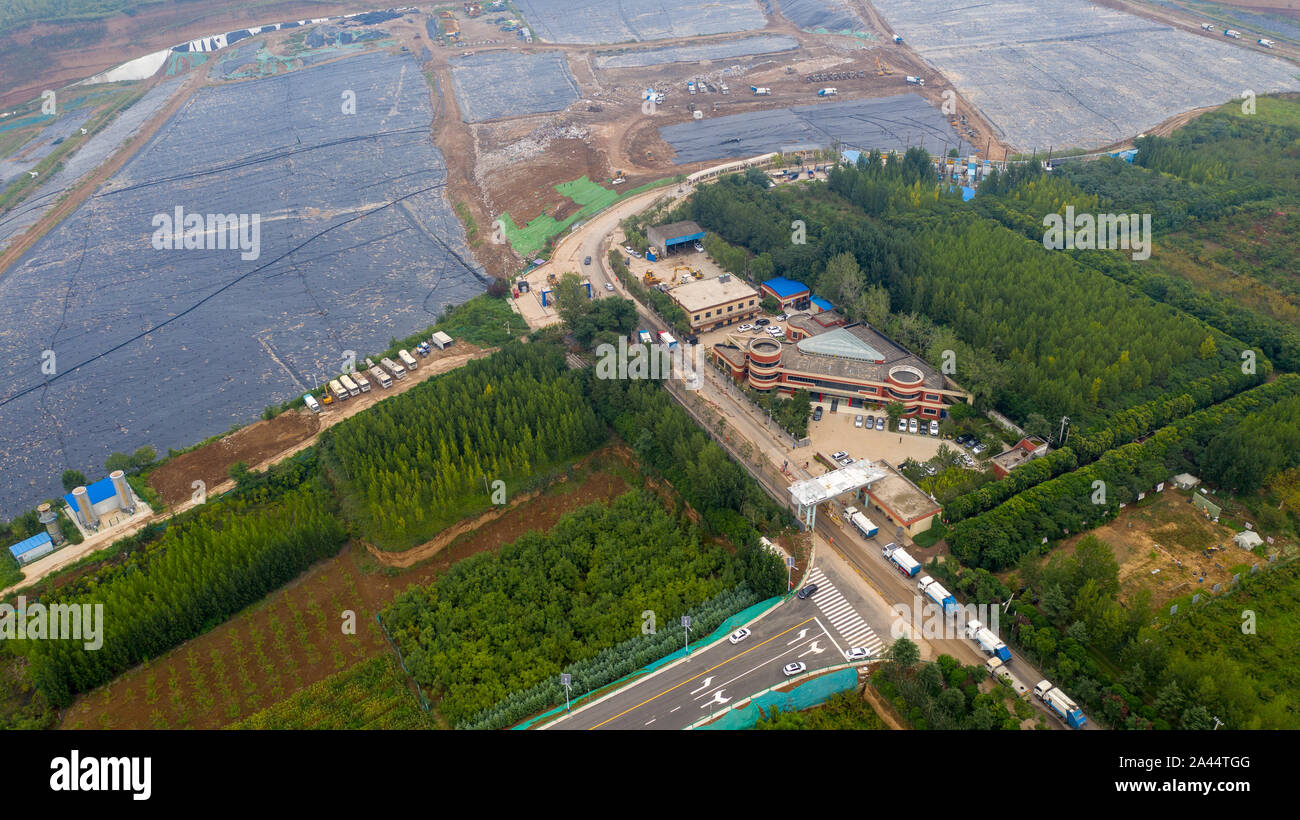 Chinese workers sort out and bury kitchen waste at the Jiangcungou ...