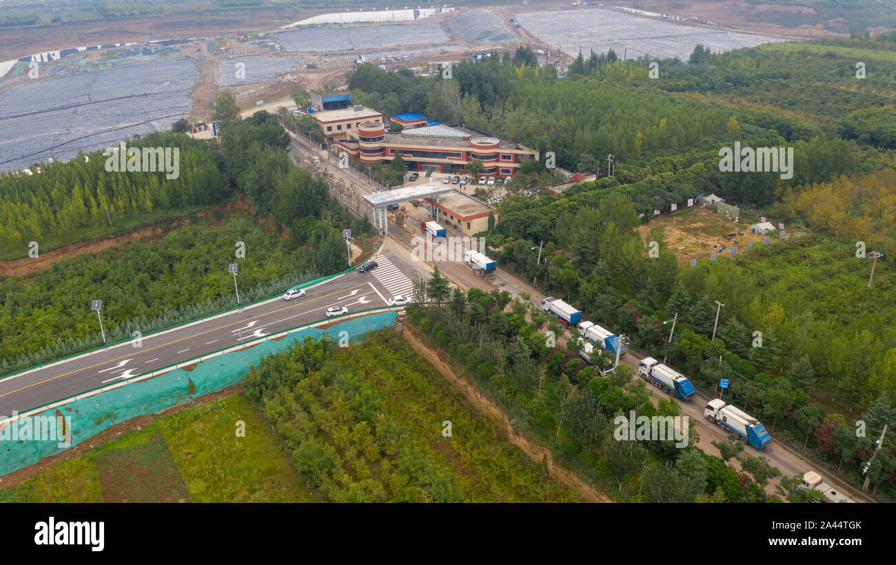 Chinese workers sort out and bury kitchen waste at the Jiangcungou ...
