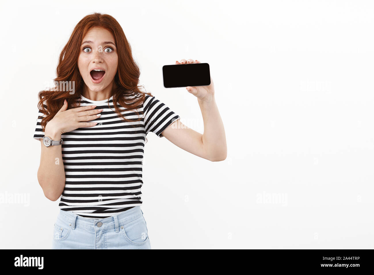 Surprised enthusiastic young female redhead gamer look speechless and ...