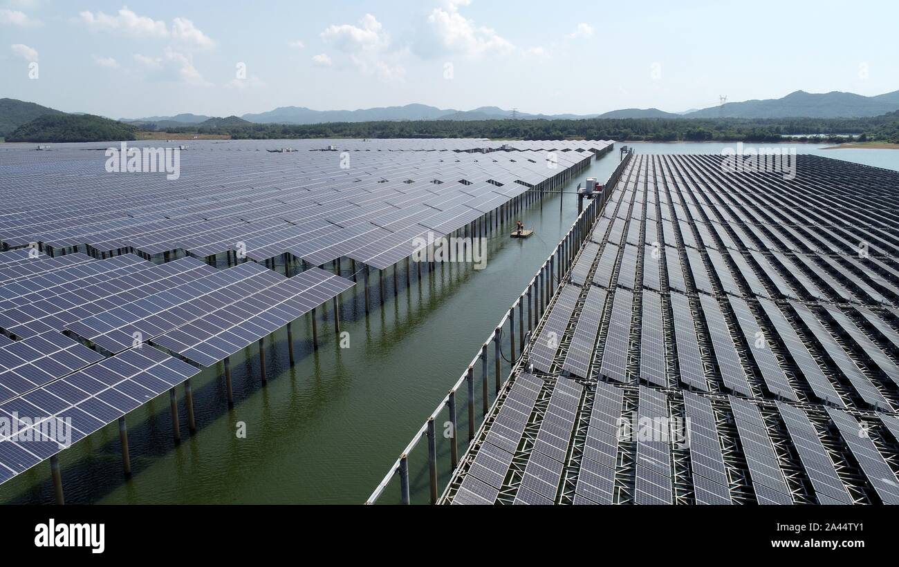 Aerial view of solar panels set at a fishing ponds, where fishermen ...