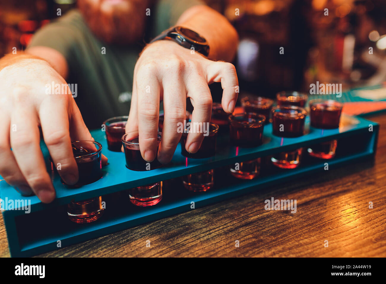 Barman make alcoholic shots with rum and liquor Stock Photo - Alamy
