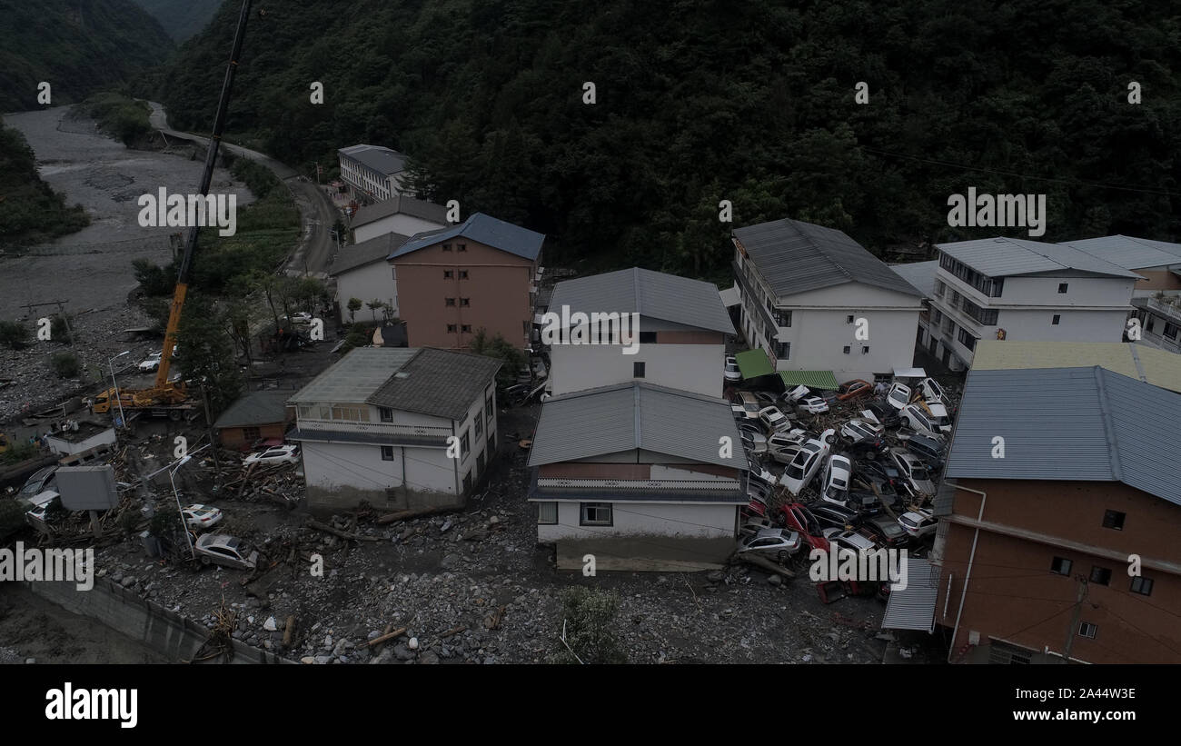 Residential buildings are covered with mud and stones after being hit ...