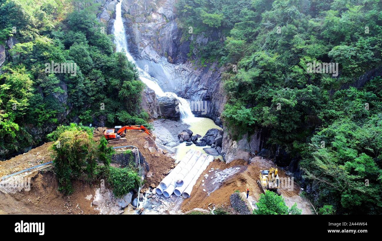Chinese workers reconstruct a road devastated by floodwater after heavy ...