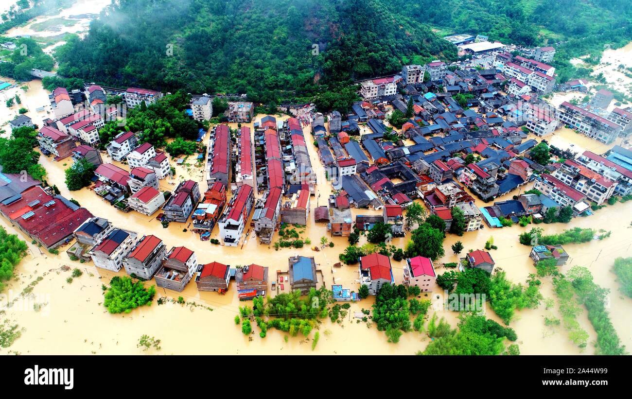 The residential buildings and fields are submerged in floodwater after ...
