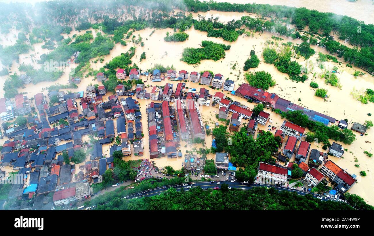 The residential buildings and fields are submerged in floodwater after ...