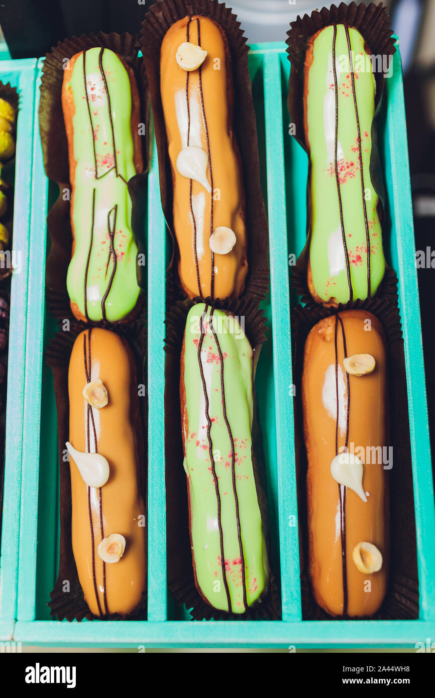 blue gift box with eclairs and macaroon Stock Photo - Alamy