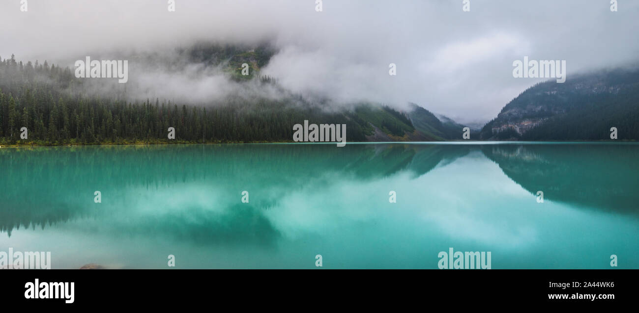 Turquoise-colored Lake Louise with reflections of the surrounding ...