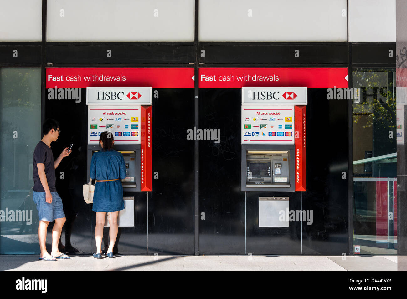 Sydney, Australia - Mar 26, 2016: People making transaction at HSBC ATM ...
